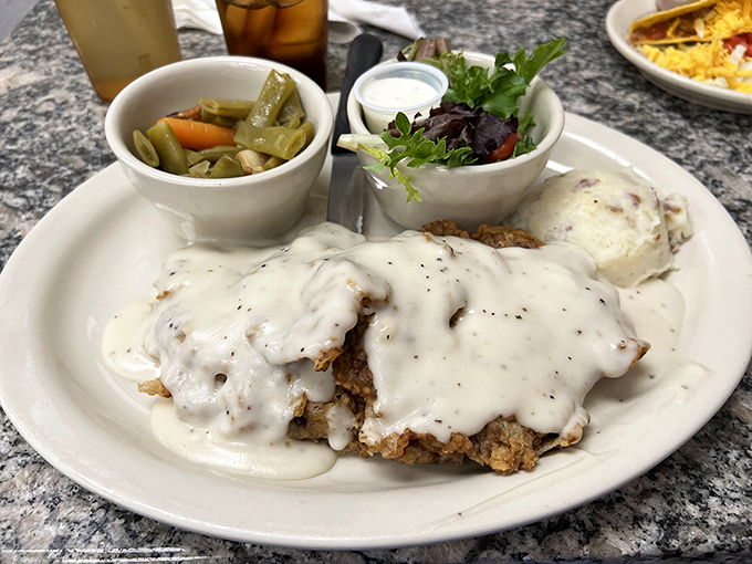 Chicken fried steak smothered in cream gravy that could make a vegetarian weep. Those pickled green beans aren't just a side—they're a palate-cleansing necessity.