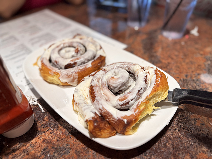 These cinnamon rolls aren't just breakfast, they're an event—pillowy dough swirled with cinnamon and crowned with cream cheese frosting that melts into every crevice.