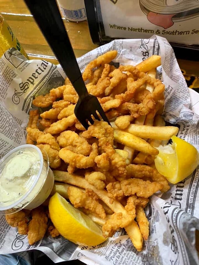 Golden-fried clam strips lounging on a bed of french fries—the seafood equivalent of finding an extra $20 in your pocket.