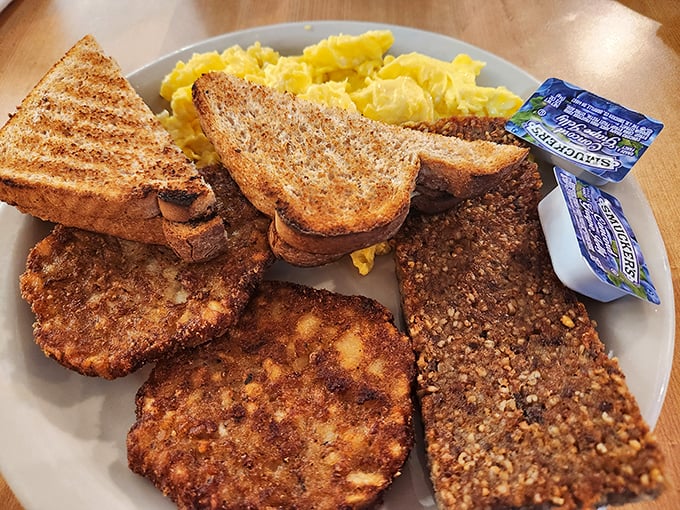 Breakfast perfection on a plate – crispy goetta patties, golden toast, and scrambled eggs that would make your grandmother nod in approval.