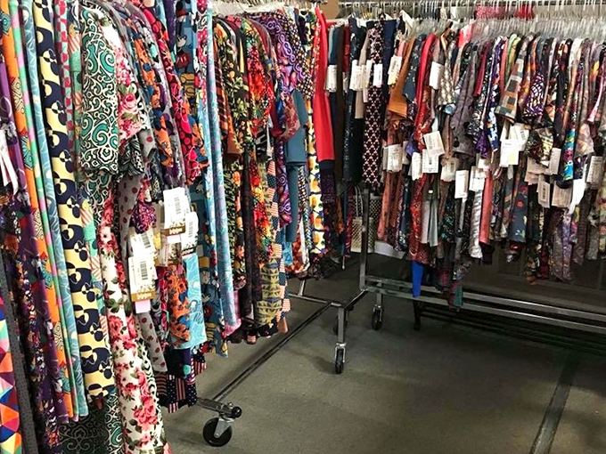 A kaleidoscope of patterns and colors hangs in perfect order, each garment waiting for its second act in someone else's wardrobe story.