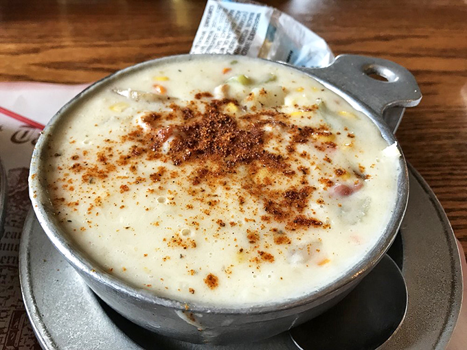 This isn't just corn chowder—it's a warm, creamy hug in a bowl, topped with a sprinkle of spice that whispers, "Take your time, the prime rib can wait."