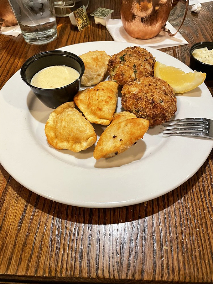 Golden-brown crab cakes that could make Maryland jealous, served with crispy potato puffs and a sauce worth bottling for emergency seafood situations.