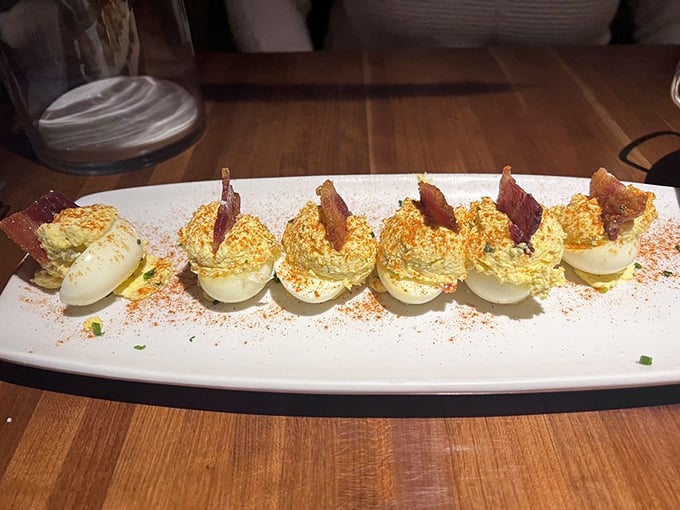 These deviled eggs with bacon aren't your grandmother's church picnic recipe—unless your grandmother was secretly a five-star chef with a flair for presentation.