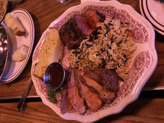 Meat and rice, perfectly plated—a harmony of flavors that makes you wonder why you'd ever eat anything else. The sauce cup is basically liquid gold.