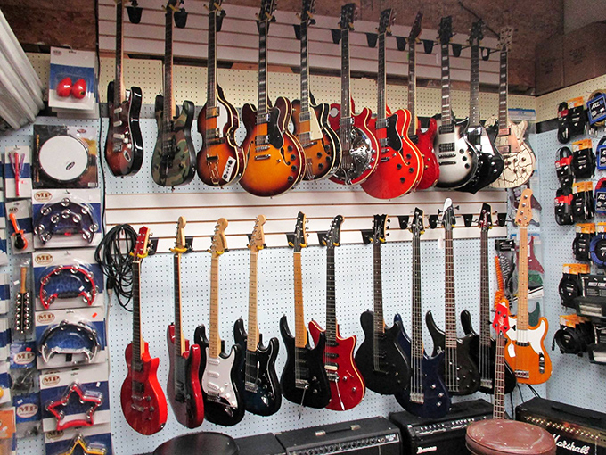 Guitar heaven for players and dreamers alike. Each instrument hanging here represents someone's abandoned rock star fantasy—or your next garage band comeback.