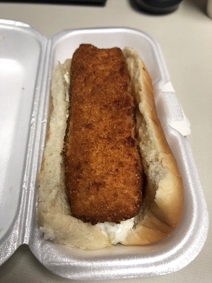 Behold the star of the show – a perfectly golden fish sandwich that makes you question whether you've ever truly experienced fish between bread before.