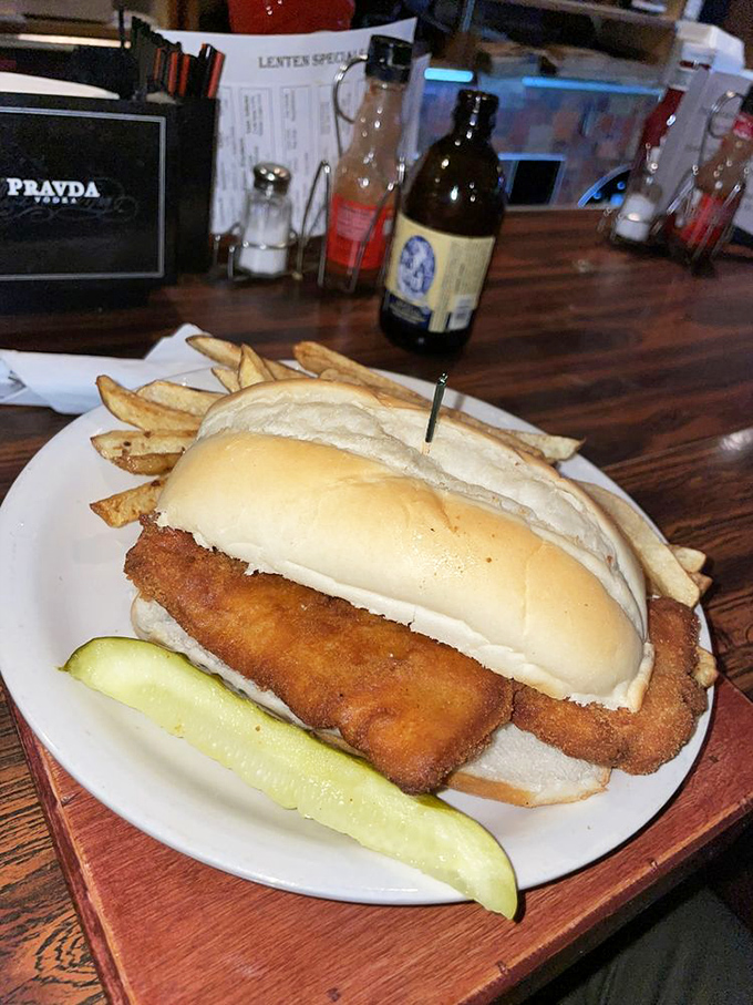 The legendary fish sandwich in all its glory—a golden-battered cod masterpiece that hangs off the bun with delicious defiance. Worth every napkin.