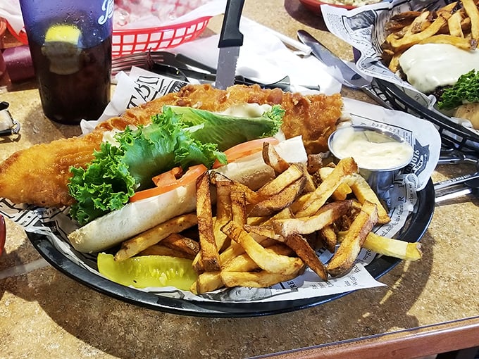 Not just any fish sandwich—this is the Moby Dick of fried fish creations. Golden-battered perfection nestled alongside hand-cut fries that would make a Frenchman weep with joy.