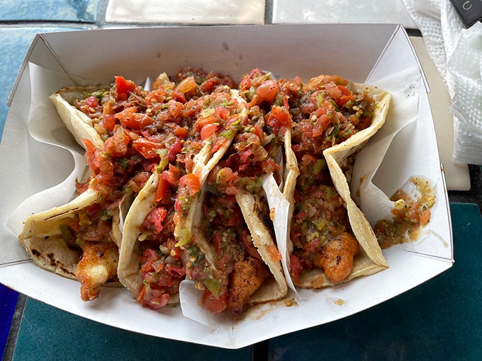 These aren't just tacos—they're edible architecture. Layers of crispy fish, fresh salsa, and cabbage creating a perfect harmony that would make Mozart jealous.