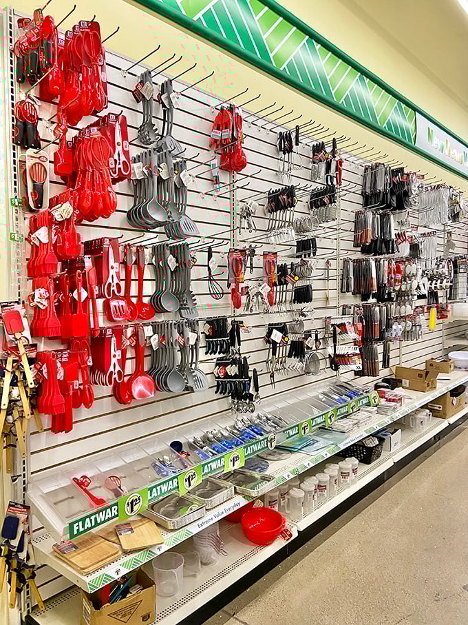 Kitchen utensil heaven! Red spatulas and ladles hang like culinary ornaments, ready to transform any amateur into a budget gourmet.