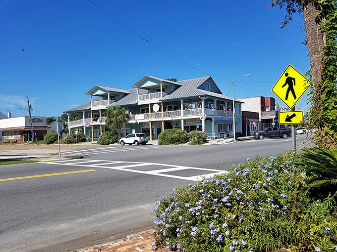 A quiet street corner in Apalachicola captures the town’s laid-back charm, where pastel facades and porch-lined buildings invite you to slow down and explore.