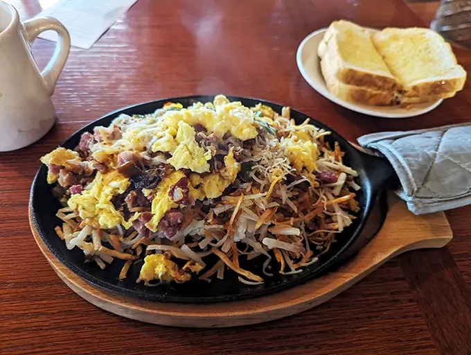 Behold the Dutch Scramble – where hash browns, eggs, and breakfast meats unite in a skillet symphony that makes morning people out of night owls.