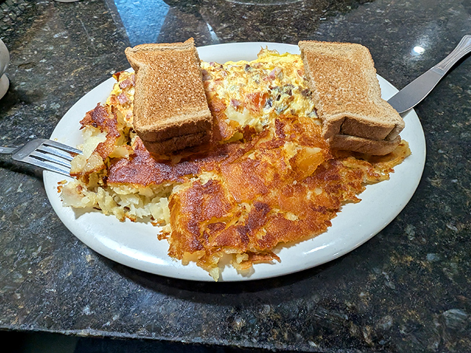 Breakfast alchemy at its finest—eggs and home fries sharing a plate in perfect harmony, like a morning symphony conducted with a spatula.