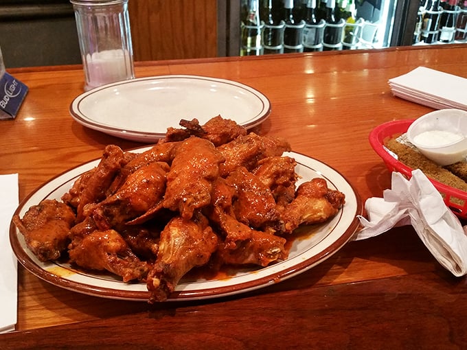 Wing perfection isn't complicated—just perfectly executed. These sauce-slathered beauties make you understand why people drive for hours just for a taste.