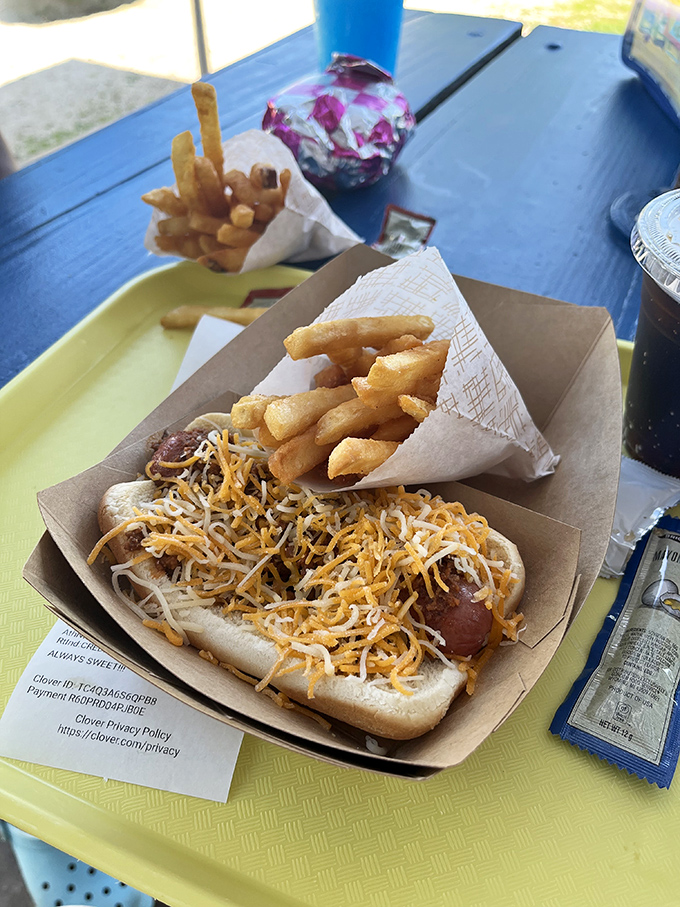 Those legendary fries—golden, crispy, almost unnaturally perfect—flanking a cheese-topped hot dog that's not trying to be fancy, just delicious.
