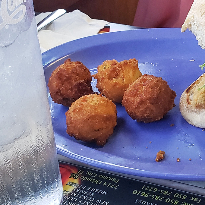 Golden orbs of cornmeal perfection that would make any Southern grandmother weep with joy. These hush puppies don't just speak—they sing.