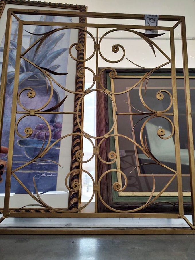 Ornate brass scrollwork that once graced someone's grand entryway now waits patiently for its renaissance moment in your garden or hallway.
