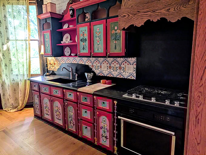 This whimsical kitchen looks like it was designed by Tim Burton during a particularly cheerful phase – folk art meets Victorian Gothic with a splash of culinary charm.