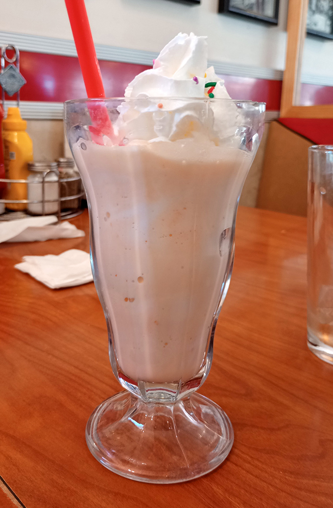 This isn't just a milkshake—it's a frothy monument to dairy perfection that demands respect, a long spoon, and possibly an extra notch in your belt.