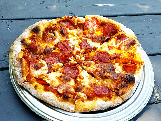 Pizza perfection doesn't need fancy words—just look at those crispy-edged pepperoni cups cradling little pools of savory magic.