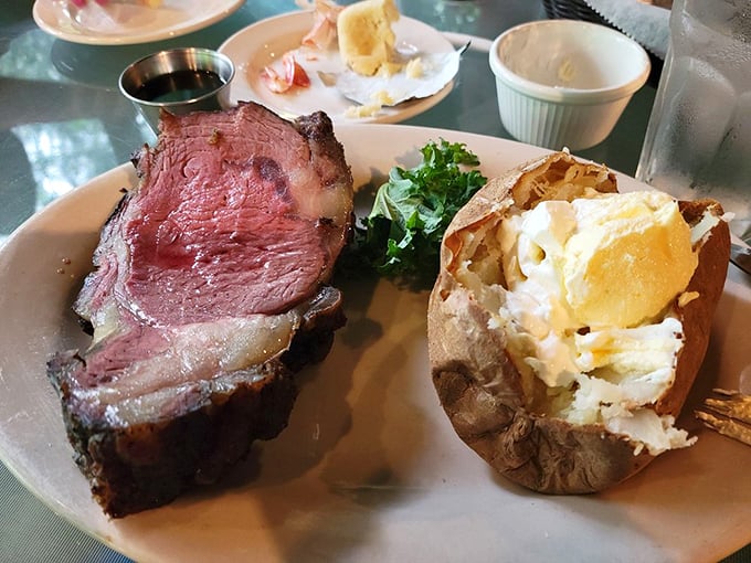 This isn't just prime rib; it's a masterclass in patience—perfectly pink, impossibly tender, with a baked potato standing by for moral support.