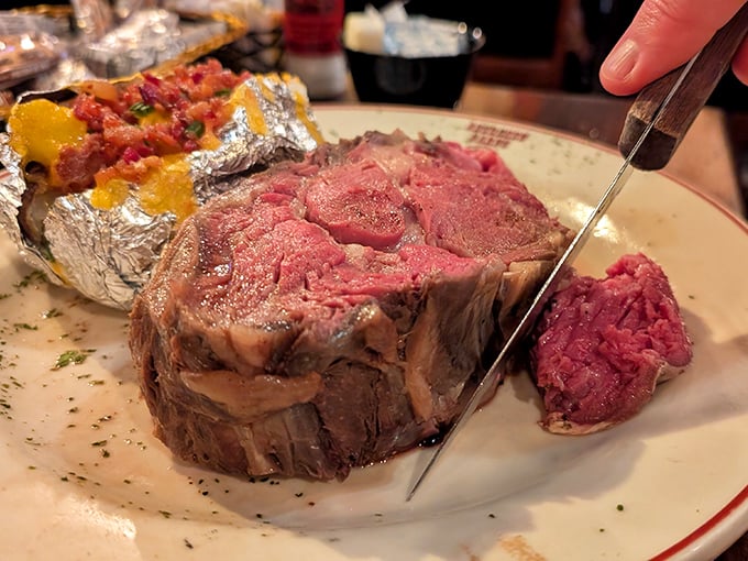 Behold the holy grail of beef—prime rib so tender it practically cuts itself, making steak knives feel slightly embarrassed.