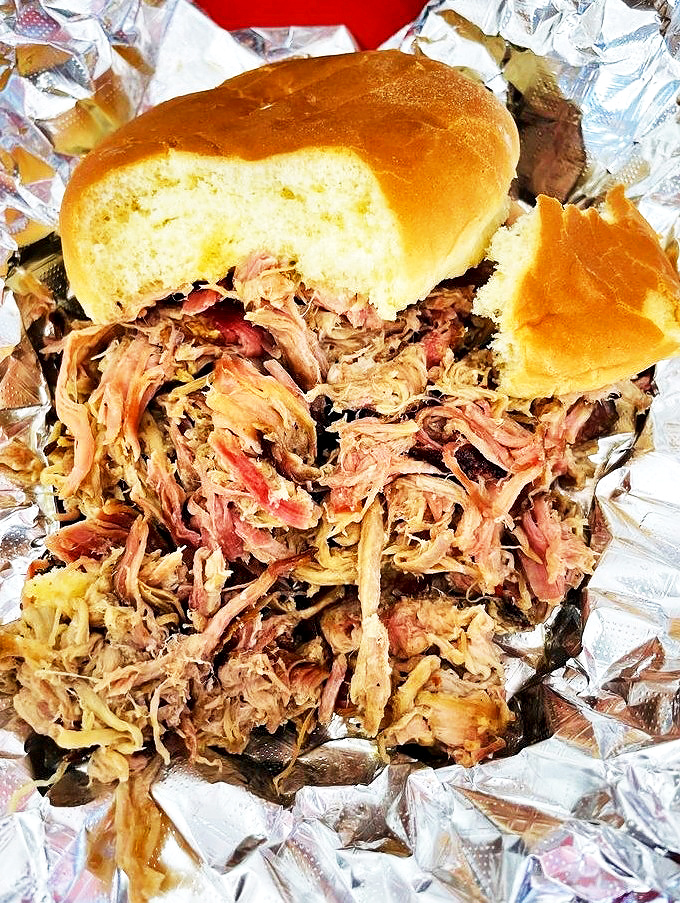This pulled pork doesn't just fall apart—it practically surrenders to gravity after hours in the smoker.