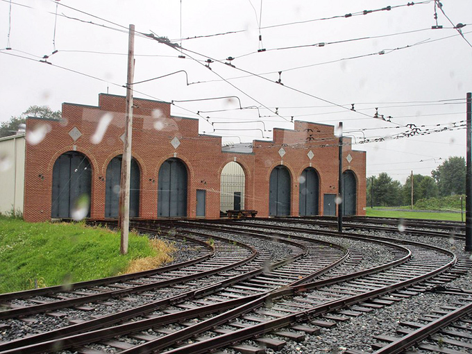 Behind the museum, a web of trolley tracks and overhead wires creates a functional transit ecosystem. Urban planning never looked so nostalgic.
