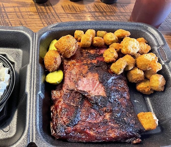 Ribs sporting that gorgeous smoke ring nestled alongside golden-fried hush puppies – a partnership more harmonious than Simon and Garfunkel.