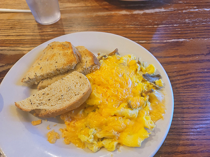 Scrambled eggs that actually taste like eggs should – fluffy, tender, and unapologetically yellow, with toast standing by for yolk patrol.