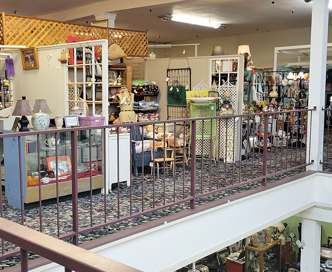 From the second floor railing, the hunt begins – like a safari where the trophies are vintage lamps and forgotten heirlooms.