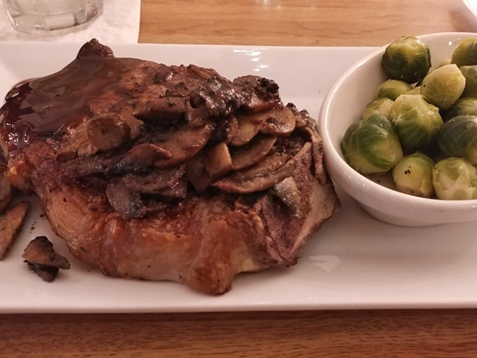 This isn't just a steak—it's a masterpiece with a side of Brussels sprouts. The perfect sear tells you everything you need to know about what's happening in that kitchen.