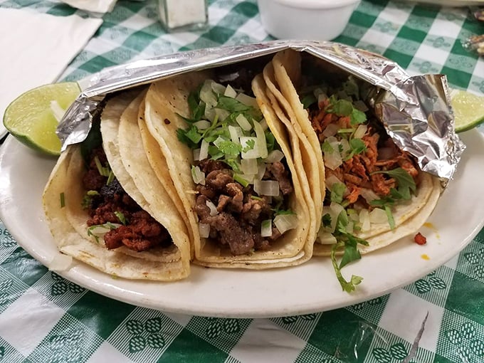 Tacos as they should be – simple, perfect, and wrapped in foil like the precious gift to humanity they truly are. That lime wedge isn't just garnish, it's essential equipment.