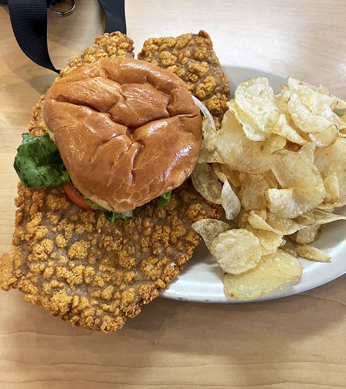 The tenderloin sandwich here isn't just bigger than the bun—it's practically staging a delicious rebellion against the concept of bread-to-meat ratio.