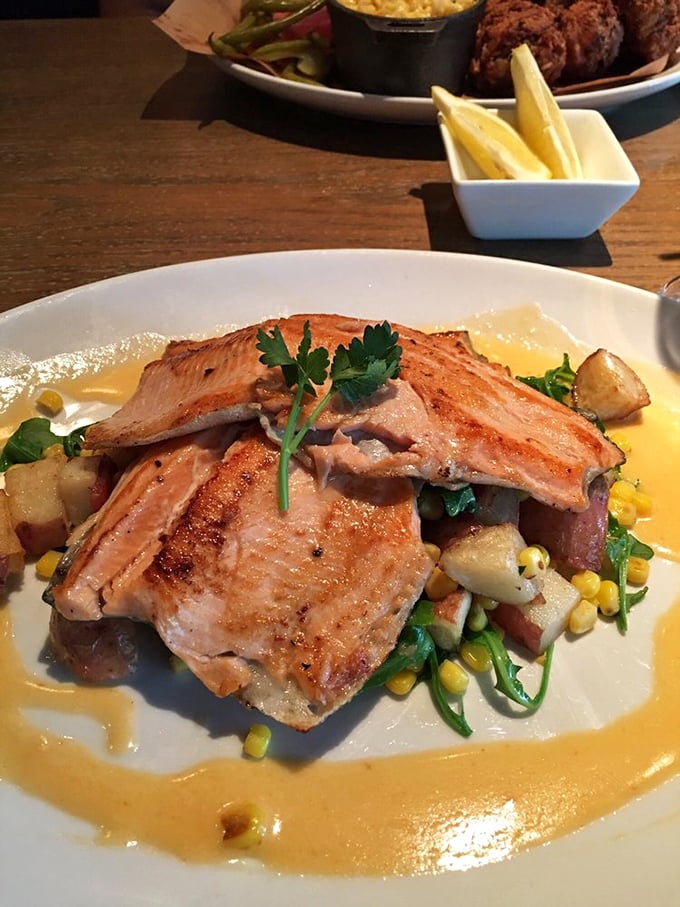 The legendary trout arrives like edible artwork – perfectly seared, resting on a bed of seasonal vegetables. This is why people drive for hours.