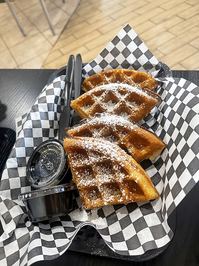 Golden waffles dusted with powdered sugar—the unexpected sweet counterpoint to Nashville heat that makes you wonder why this combo isn't everywhere.