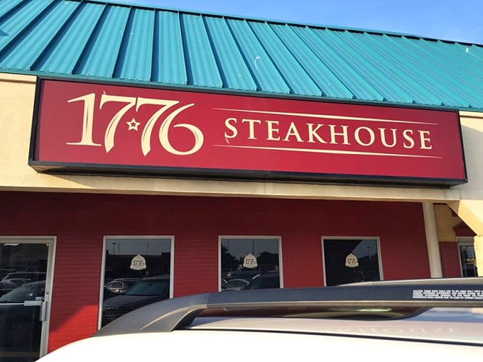 The patriotic red facade of 1776 Steakhouse reminds us that life, liberty, and the pursuit of perfect steak are inalienable rights.