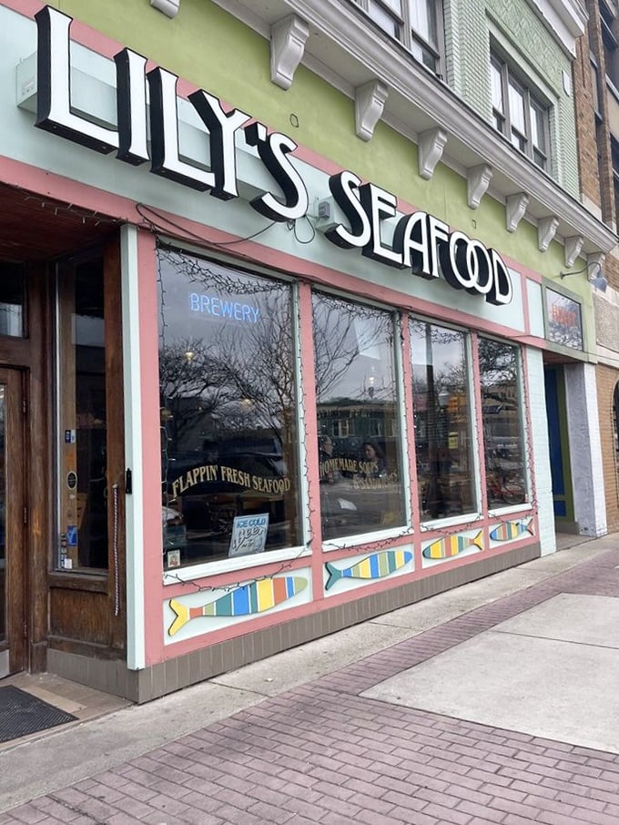 Lily's pink-and-green facade pops against the cityscape – as colorful as the seafood creations waiting inside.