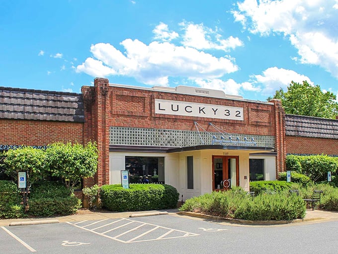 Lucky 32's brick facade stands proud against Carolina blue skies – a temple to Southern cooking where chicken prayers are answered daily.