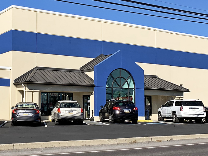 The blue and cream exterior of Re-Uzit Shop stands out like a beacon for bargain hunters.