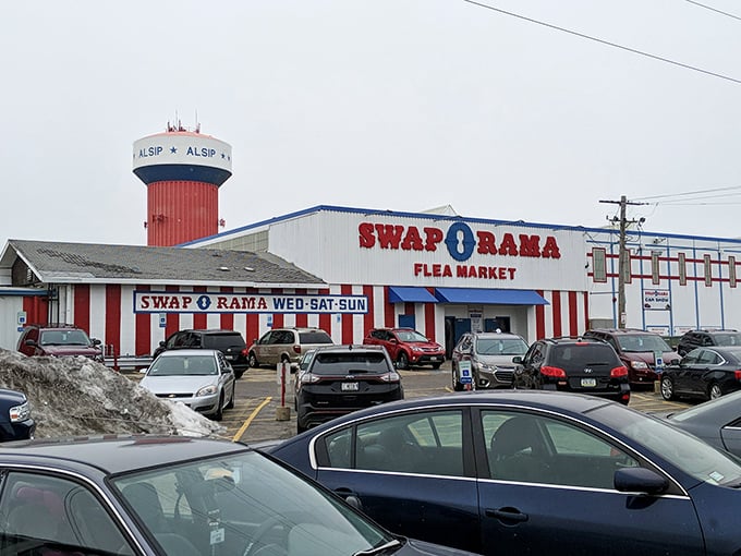 The iconic red and white stripes of Swap-O-Rama stand tall against the sky, like a circus where the main attraction is amazing deals.