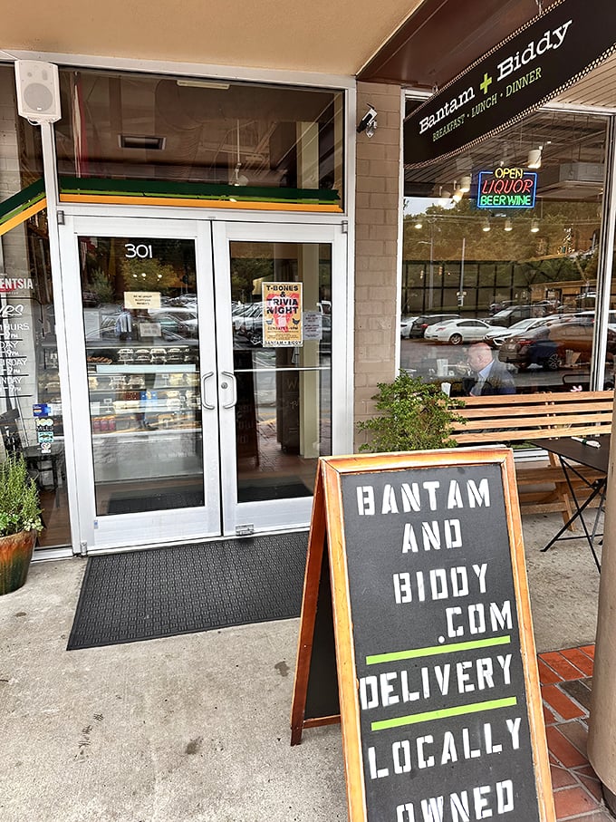 That sandwich board speaks truth – when bantam meets biddy, crispy magic happens inside this unassuming storefront.