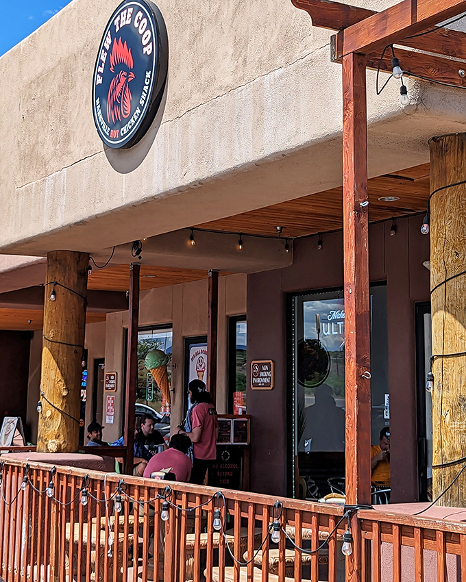 That wooden porch practically whispers "come sit a spell" while promising fiery chicken adventures inside.