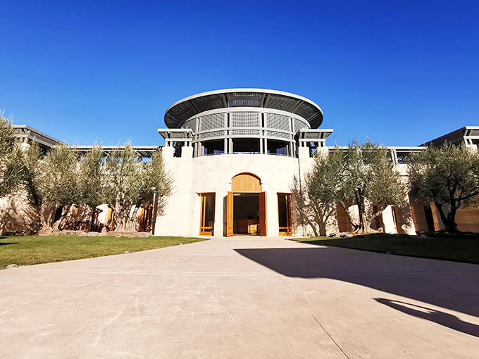 Serenity in stone and olive trees. Opus One's courtyard feels like the world's most exclusive Mediterranean retreat.