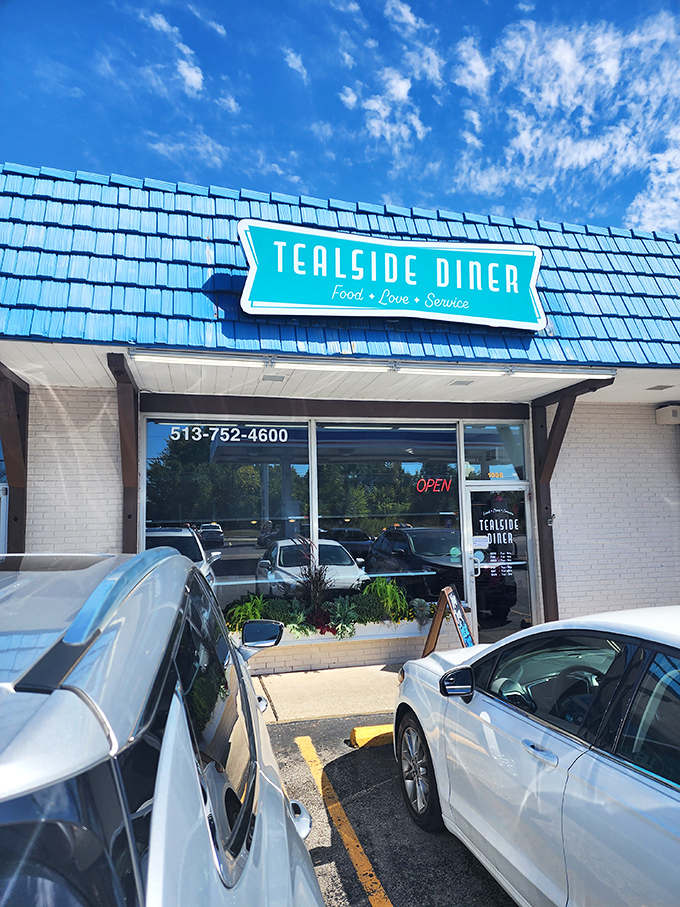 Morning sunshine makes that distinctive turquoise roof pop! A cheerful exterior that hints at the warm welcome waiting inside.