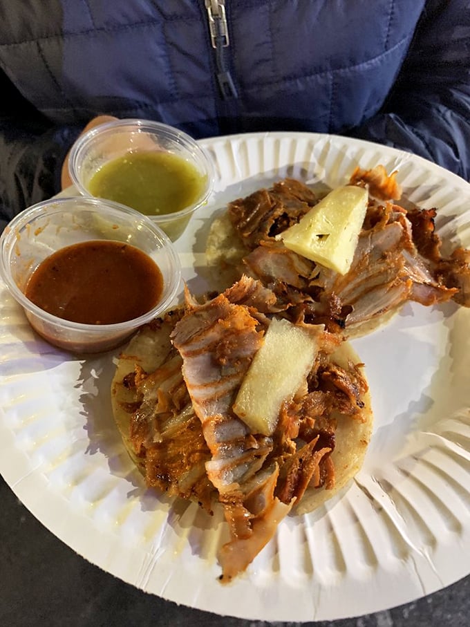 Al pastor tacos with the signature pineapple crown—proof that fruit on savory food isn't just for controversial pizza debates.