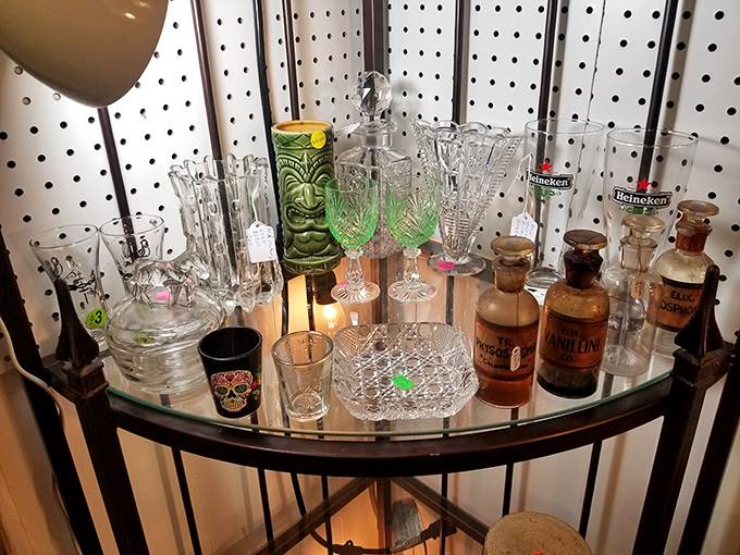 A mixologist's dream collection of vintage glassware and tiki mugs. That green tiki glass has definitely served some legendary cocktails in its day.