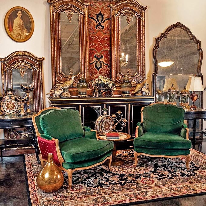 These emerald velvet armchairs flanking an ornate cabinet aren't just furniture – they're time machines to an era when "streaming" meant something entirely different.