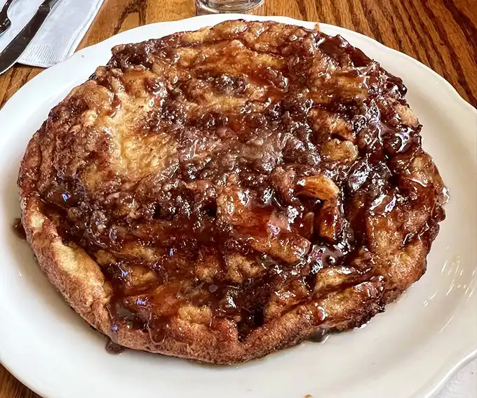 The legendary Apple Pancake—a caramelized monument to morning indulgence that makes ordinary pancakes look like they're not even trying.